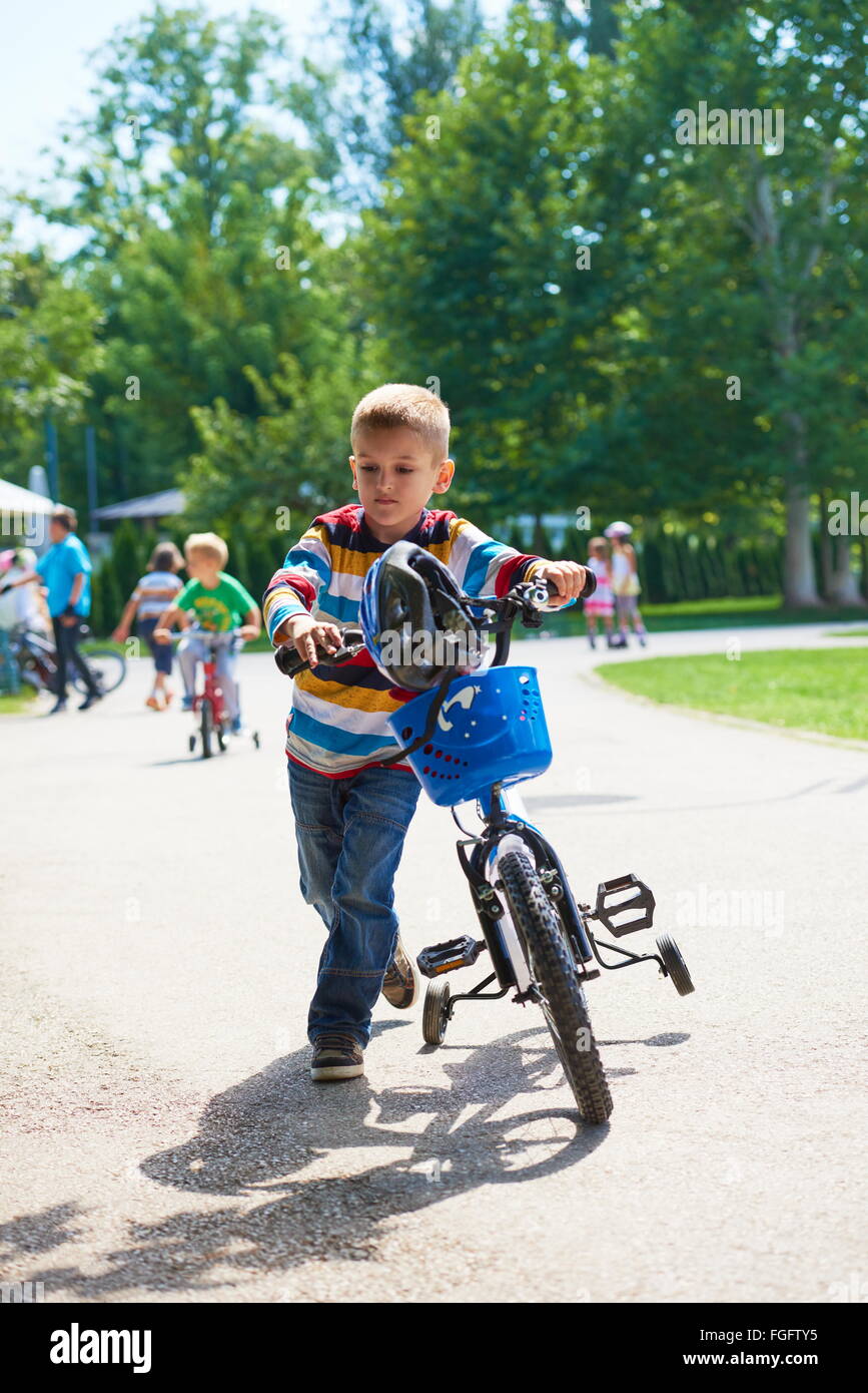 happy boy learning to ride his first bike Stock Photo - Alamy