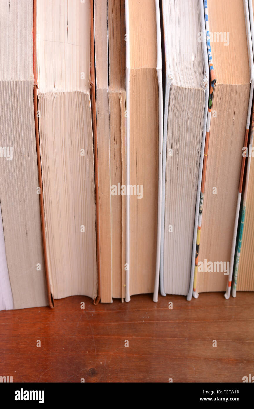 Old books leaning against each other for sale Stock Photo - Alamy