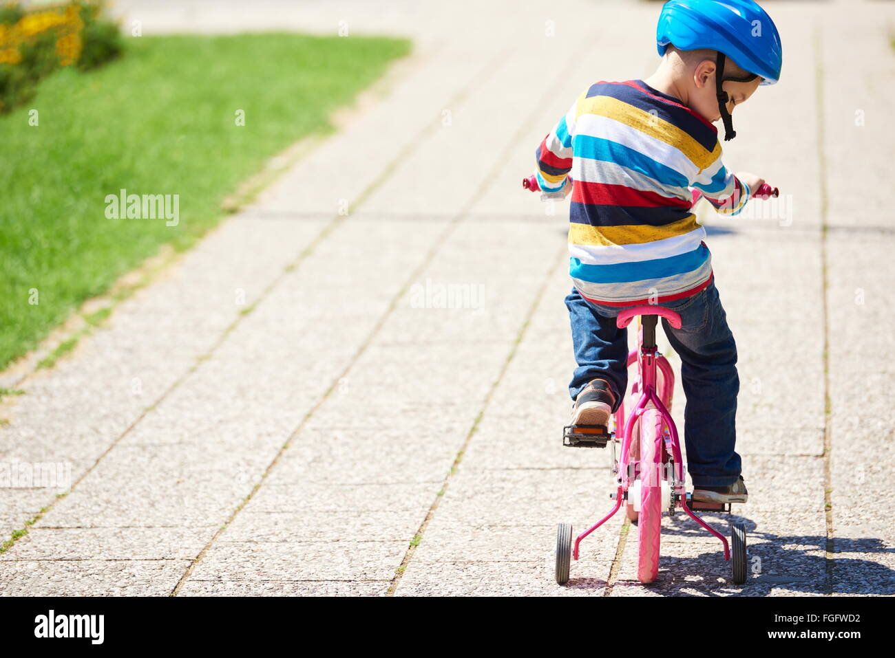 happy boy learning to ride his first bike Stock Photo - Alamy