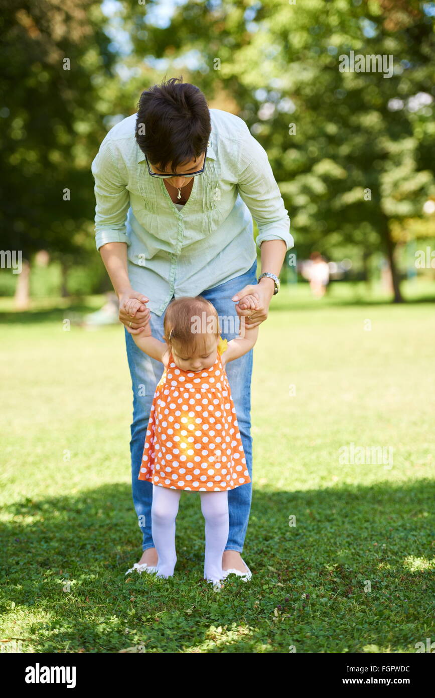mother and baby in park making first steps Stock Photo - Alamy