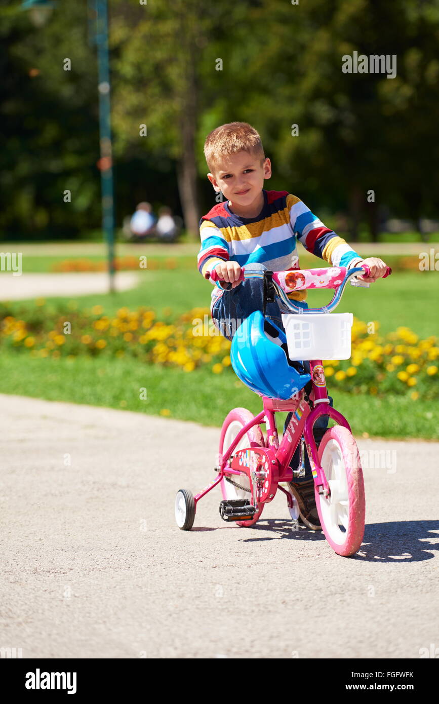 happy boy learning to ride his first bike Stock Photo - Alamy