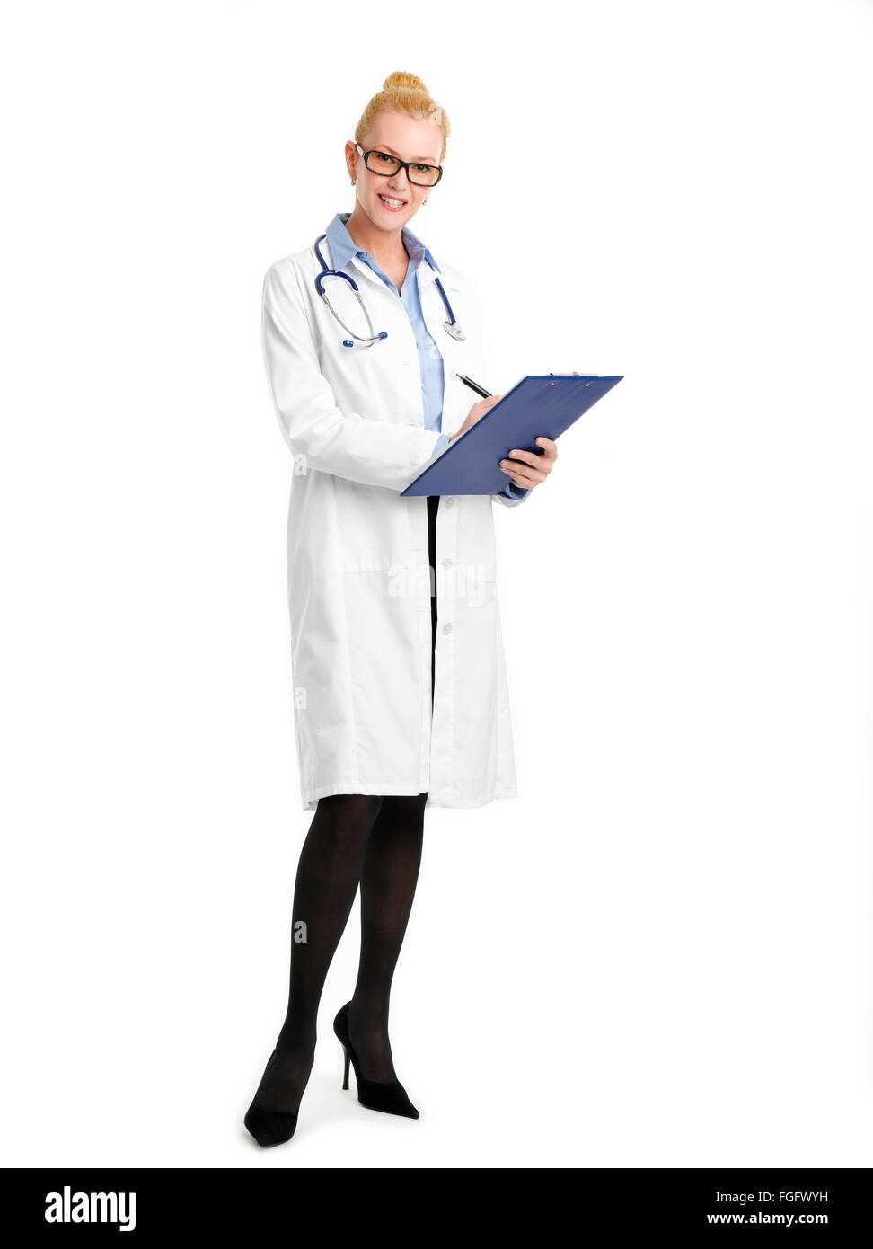 Full length portrait of female doctor standing agains white background ...