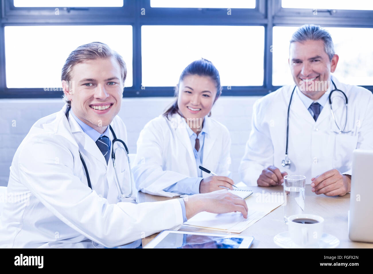Medical team smiling at conference room Stock Photo - Alamy