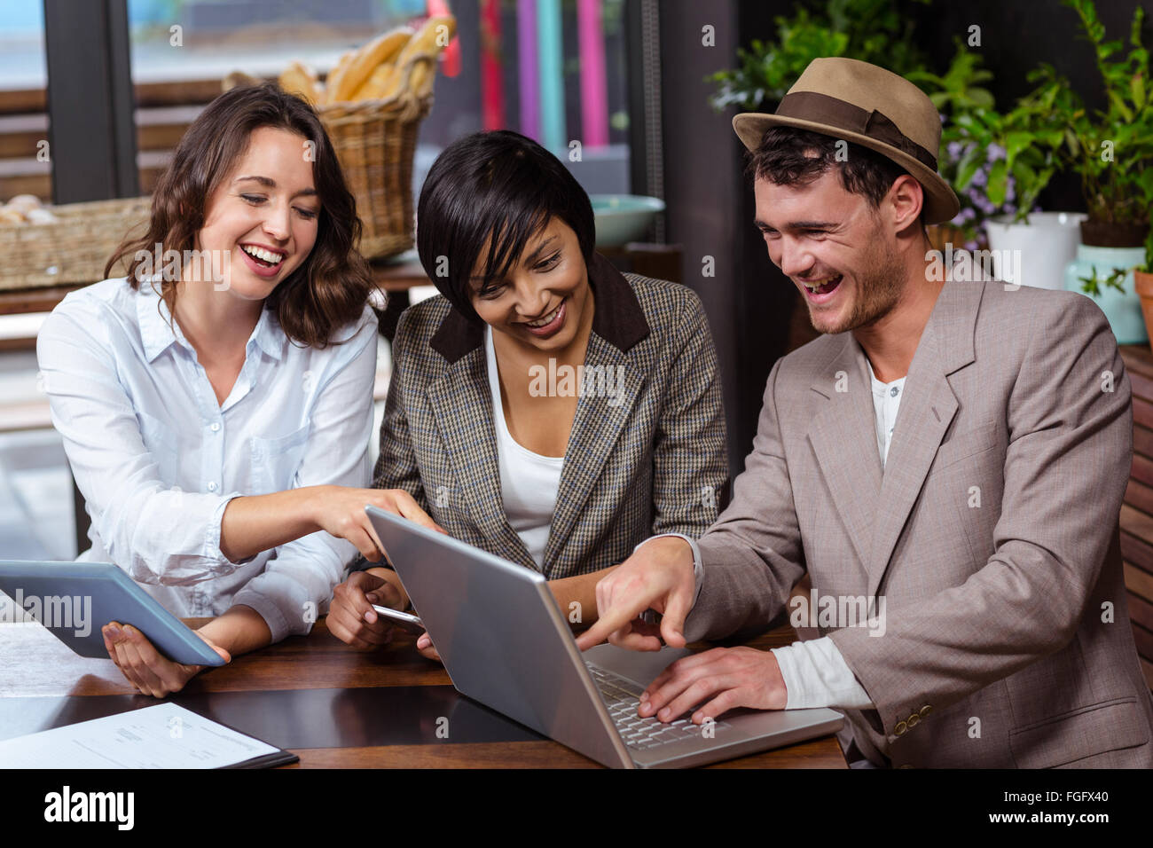 Friends using technology together Stock Photo - Alamy