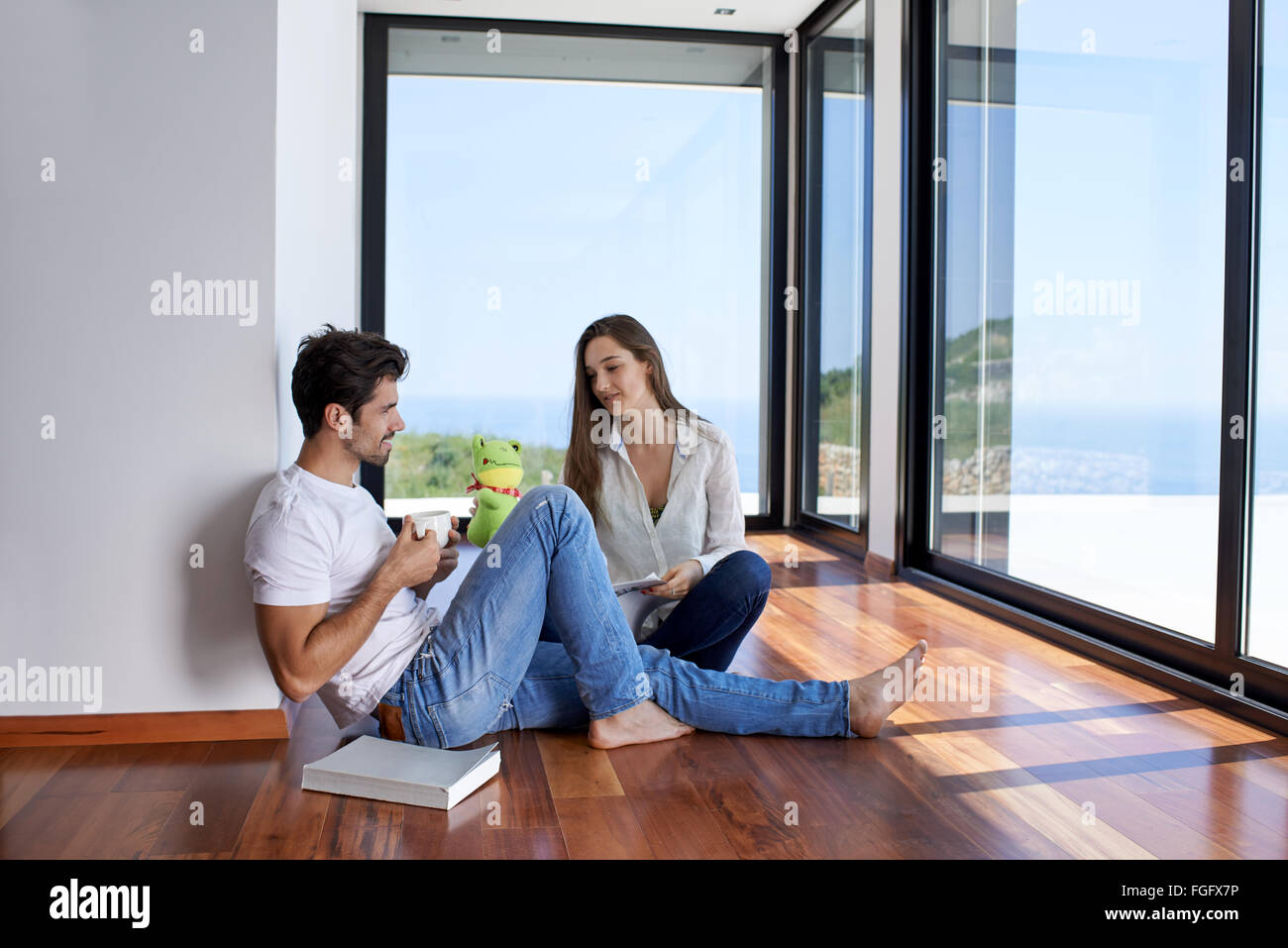 relaxed young couple at home staircase Stock Photo - Alamy