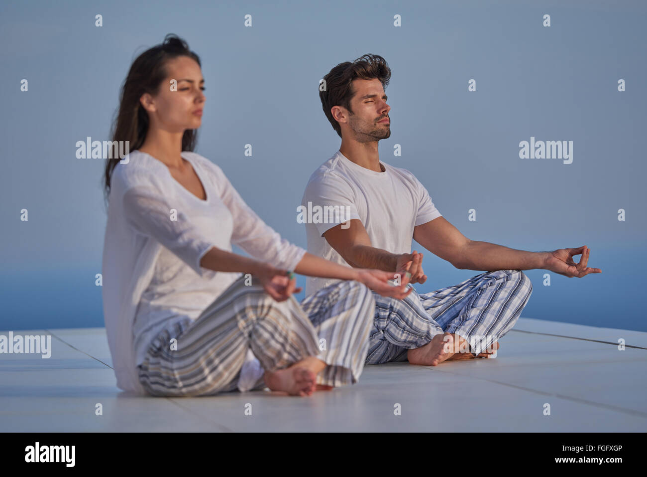 young couple practicing yoga Stock Photo - Alamy
