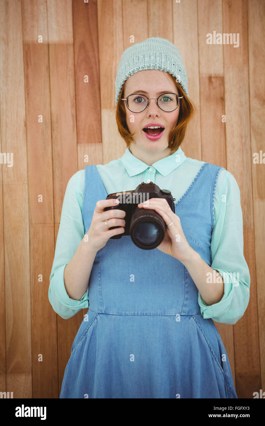 Red haired hipster holding camera Stock Photo - Alamy