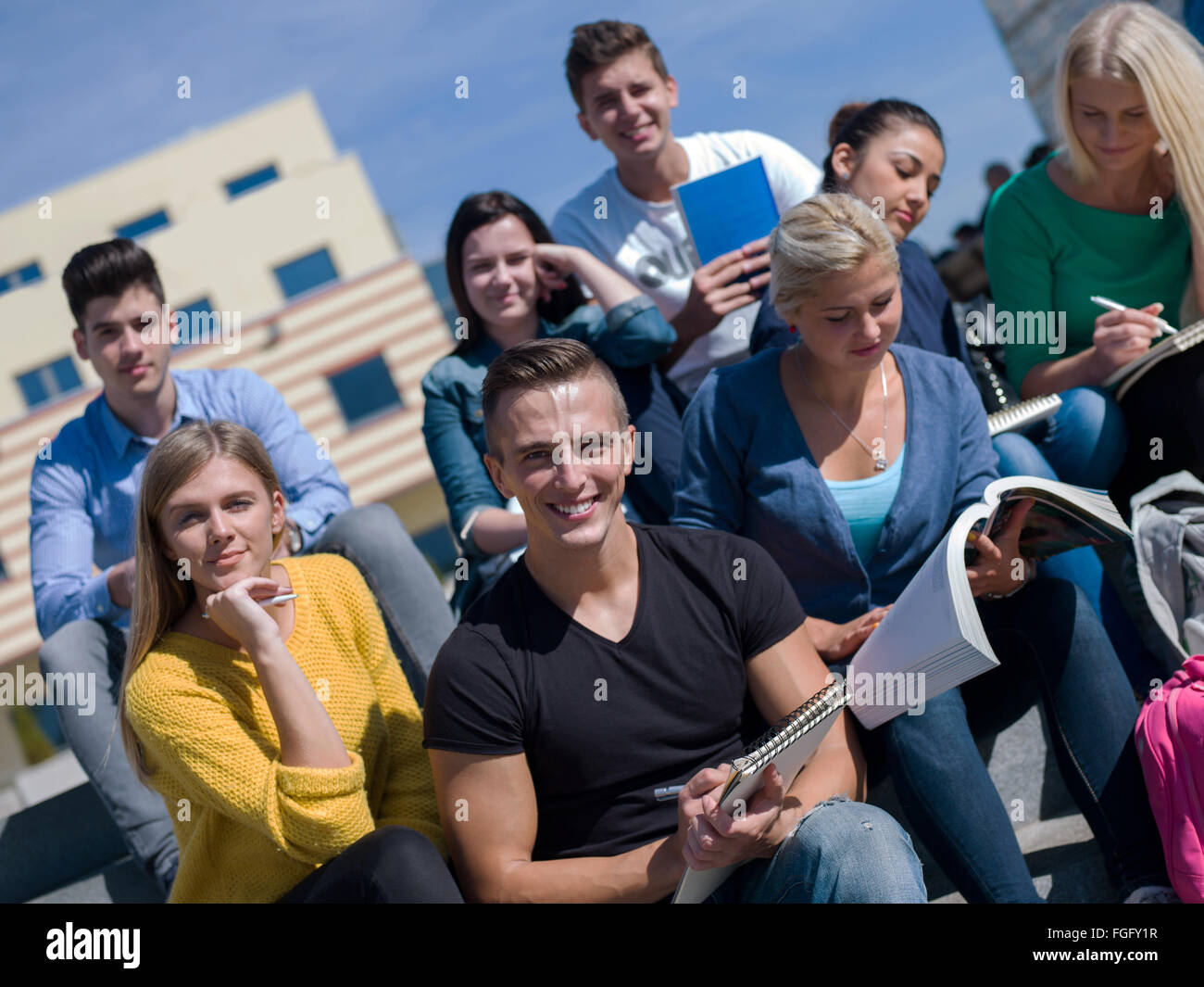 students outside sitting on steps Stock Photo - Alamy