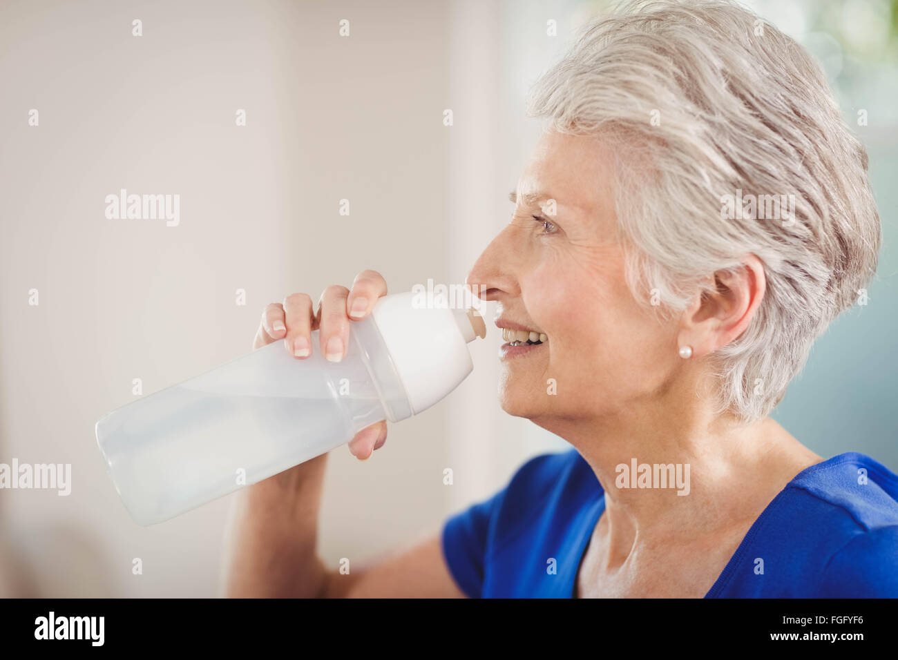 Happy senior woman drinking water Stock Photo - Alamy