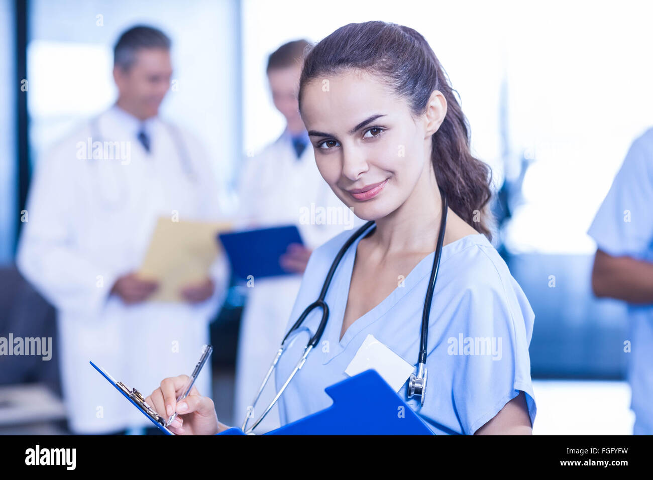 Female doctor writing a medical report Stock Photo - Alamy