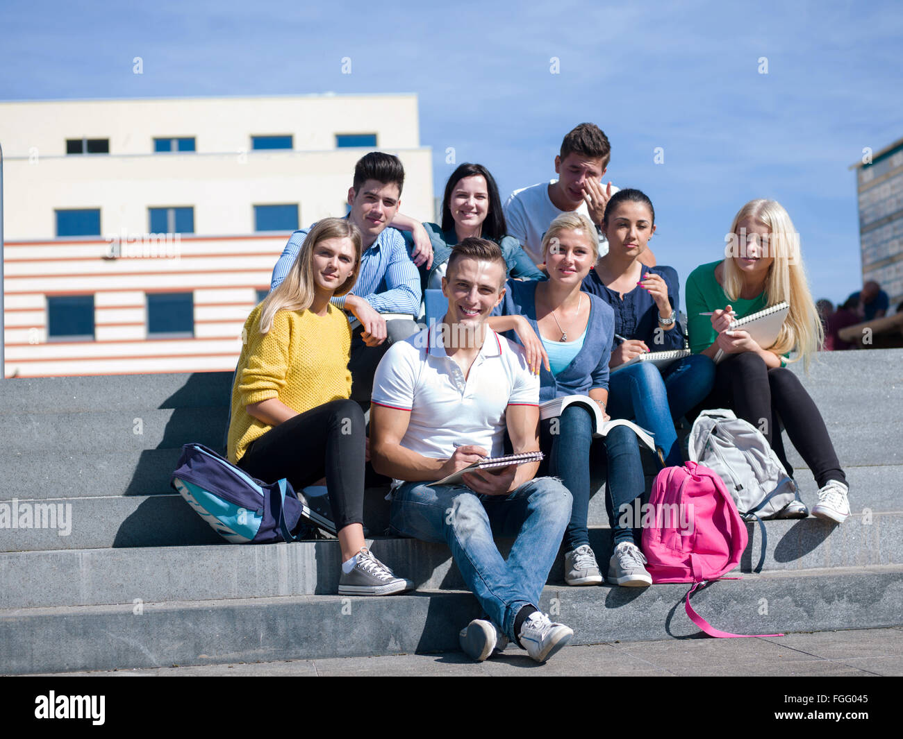 students outside sitting on steps Stock Photo - Alamy