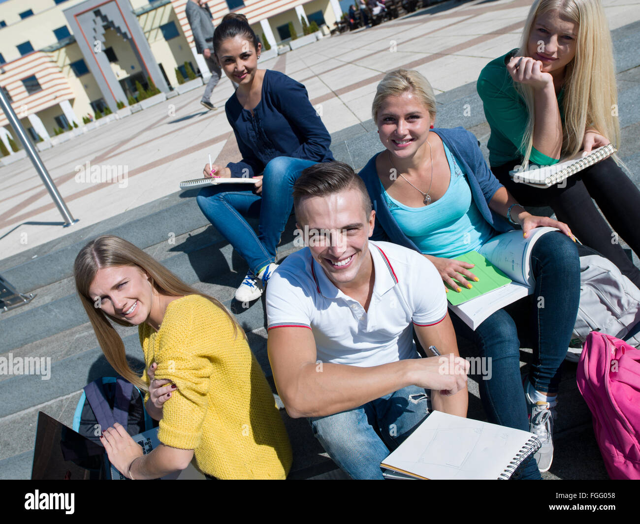 students outside sitting on steps Stock Photo - Alamy