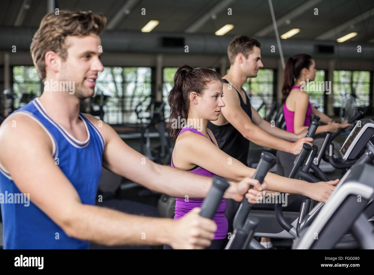 Fit people on elliptical bike Stock Photo - Alamy