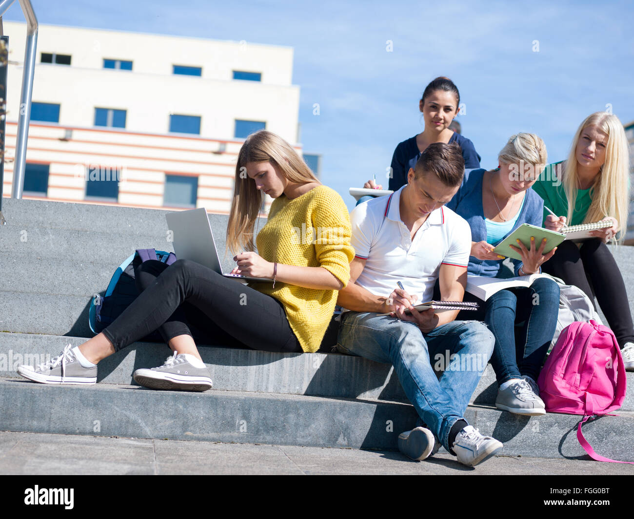 students outside sitting on steps Stock Photo - Alamy