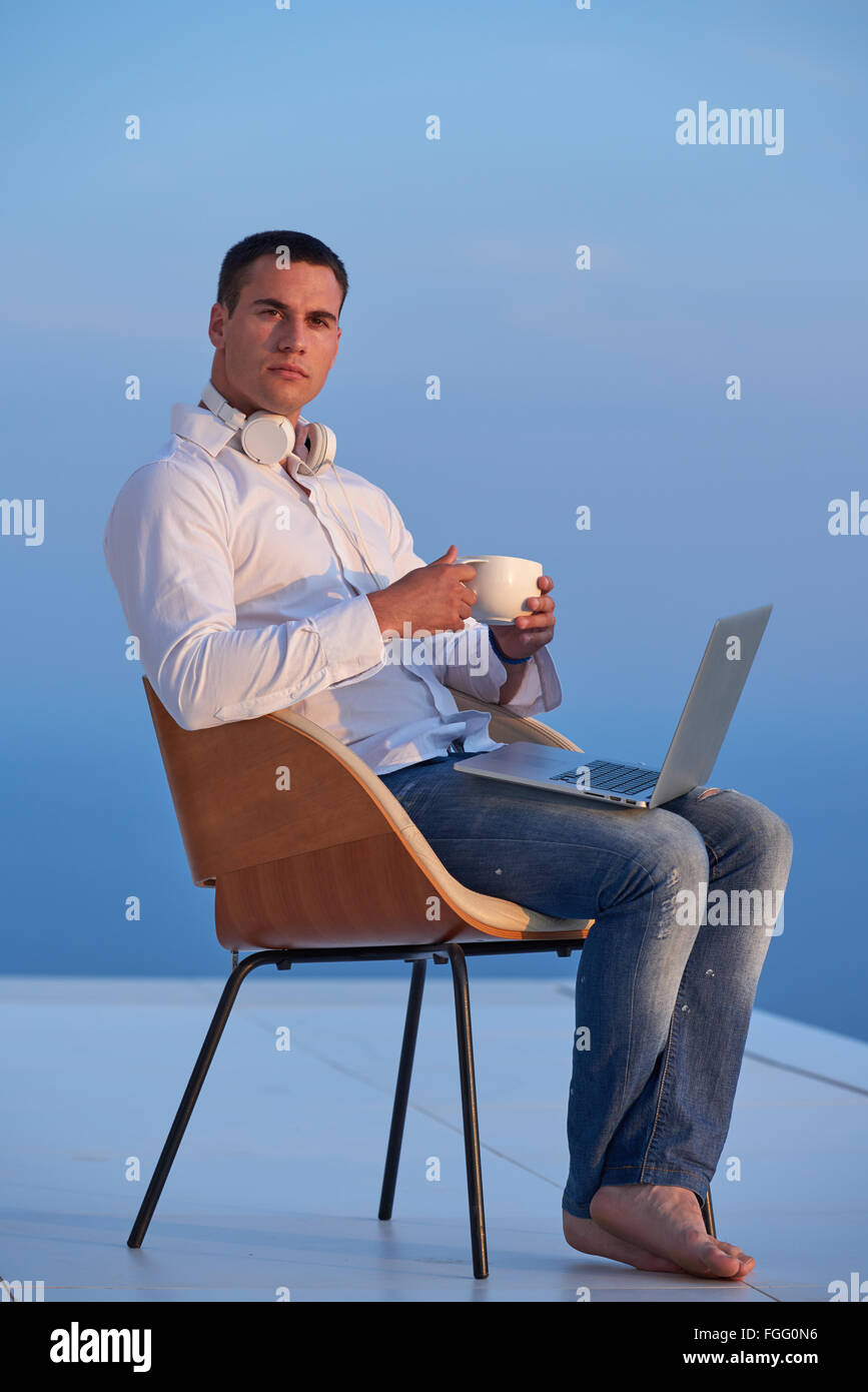 Relaxed young man working hi-res stock photography and images - Alamy