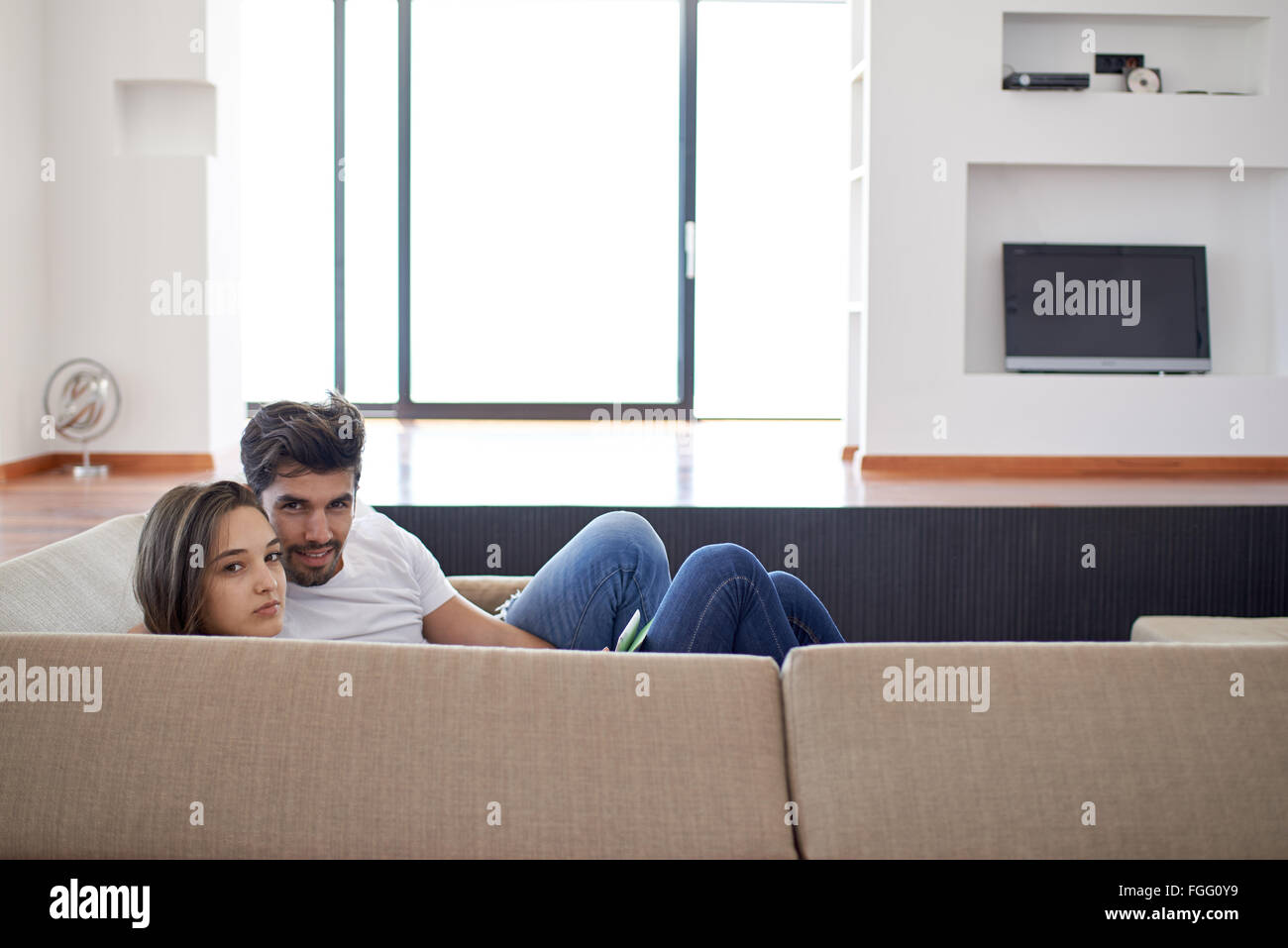 relaxed young couple at home staircase Stock Photo - Alamy