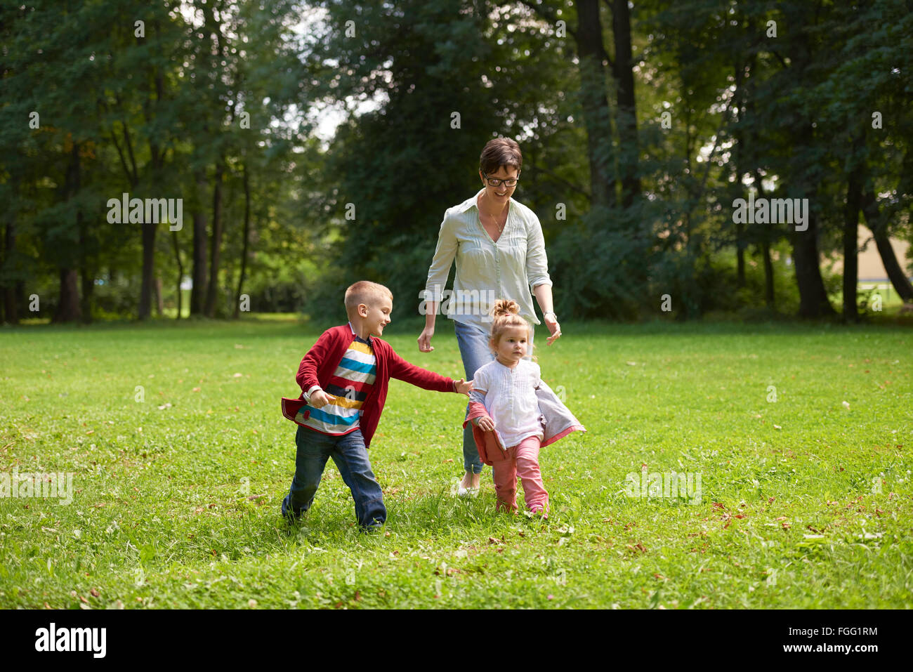 happy family playing together outdoor in park Stock Photo - Alamy
