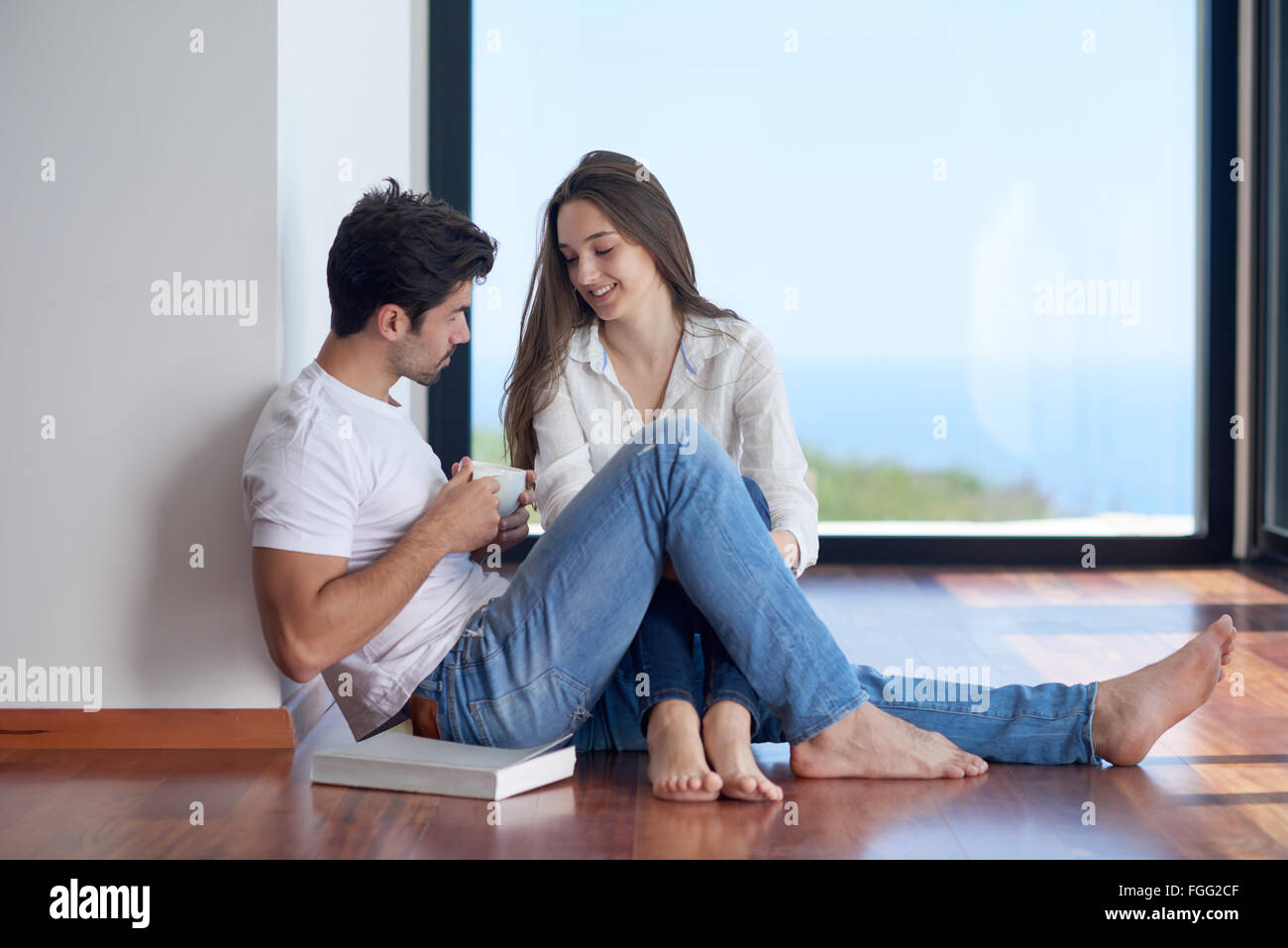 relaxed young couple at home staircase Stock Photo - Alamy