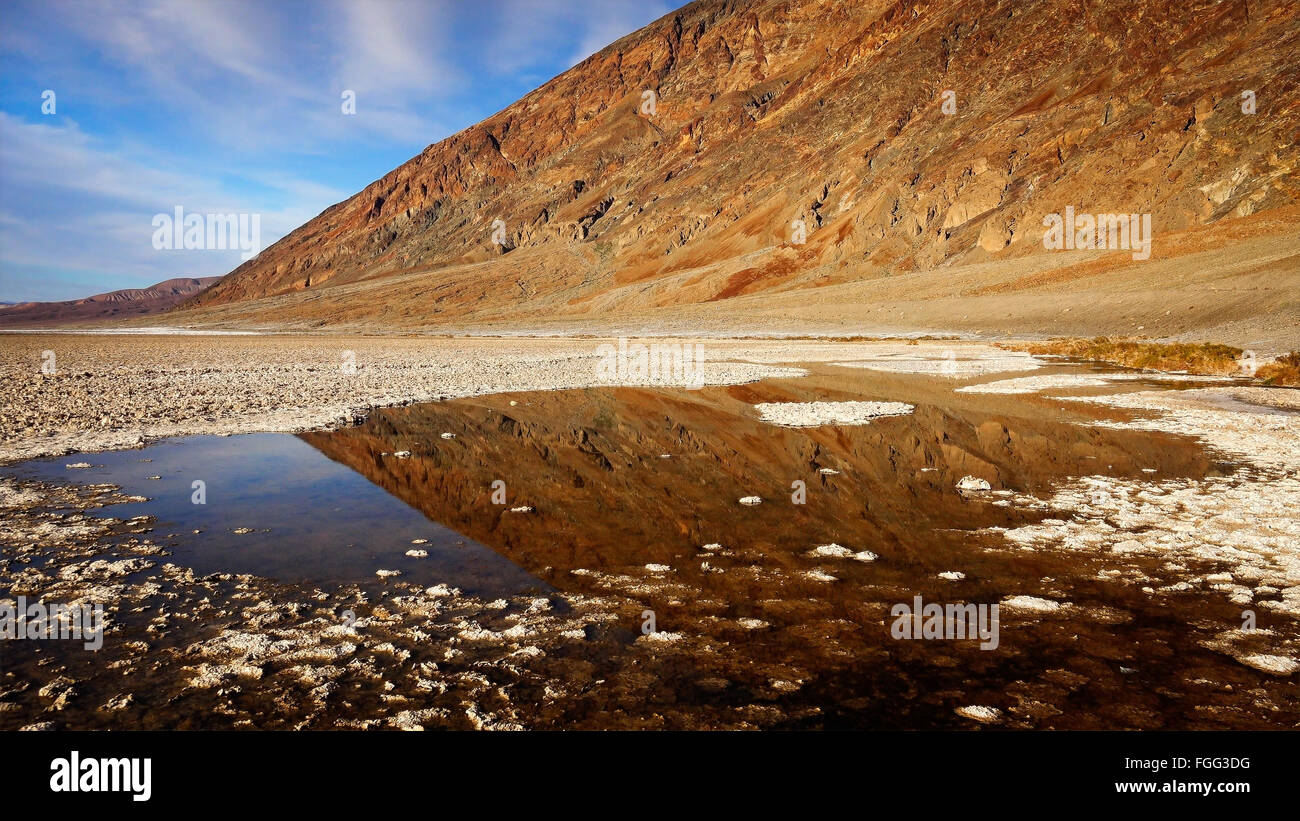 A small pool of water in Badwater Basin in Death Valley National Park ...