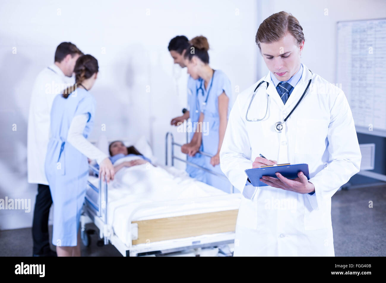 Doctor writing on clipboard Stock Photo - Alamy
