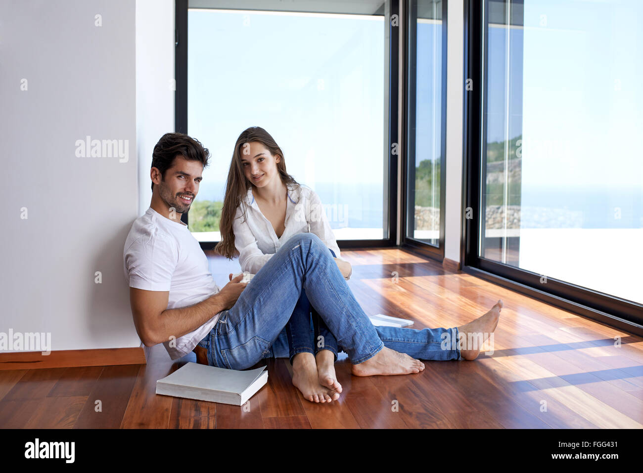 relaxed young couple at home staircase Stock Photo - Alamy