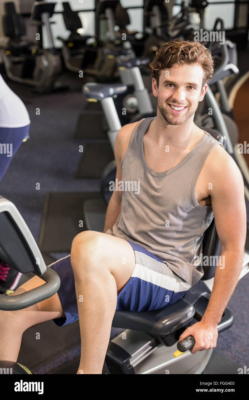Fit man doing exercise bike Stock Photo - Alamy