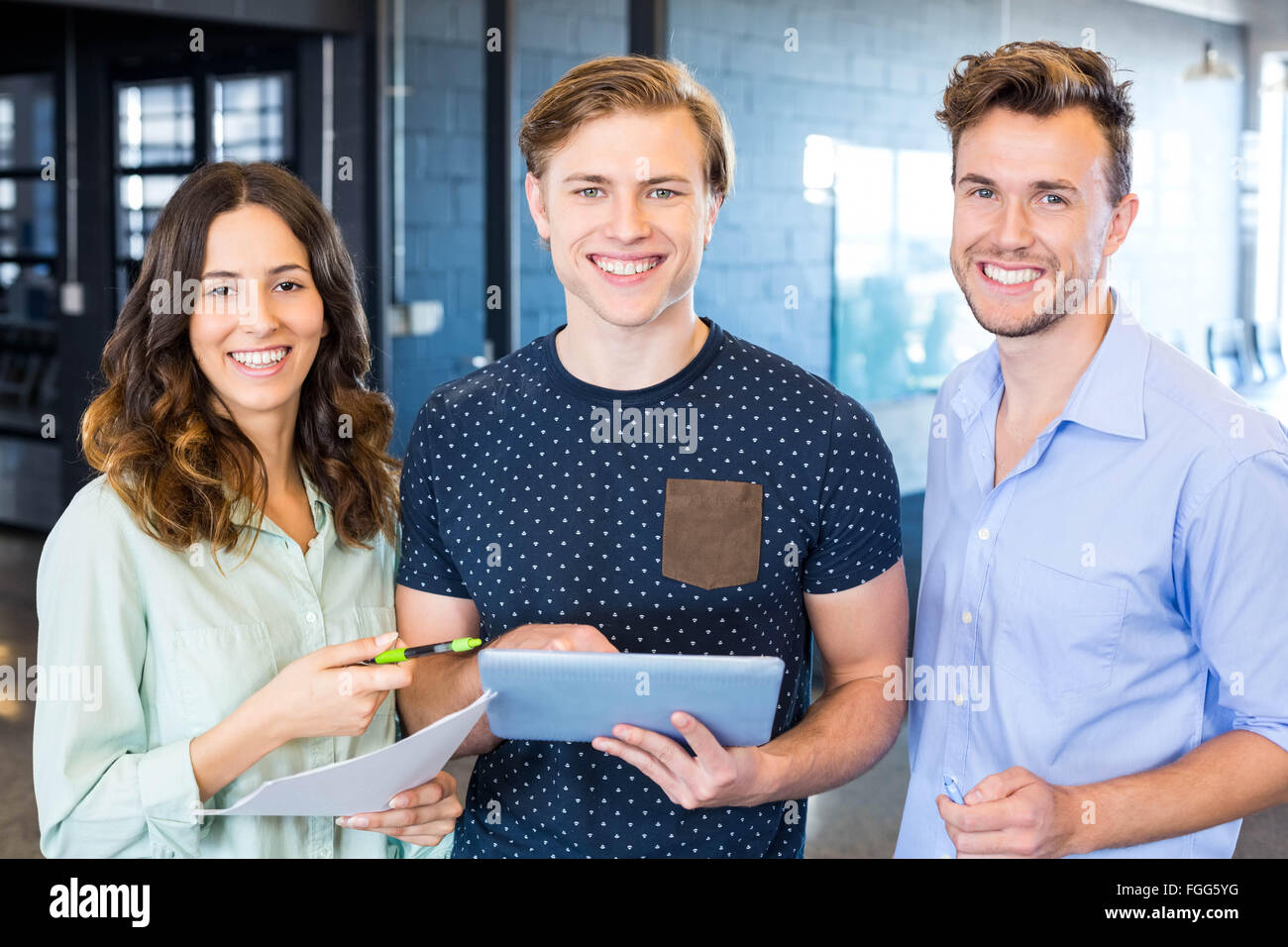 Three confident colleagues discussing in office Stock Photo - Alamy