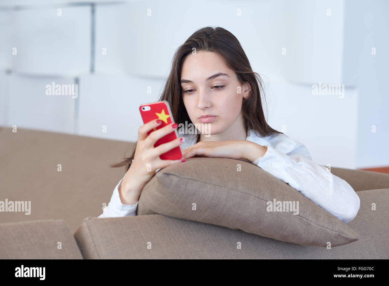 young woman using cellphone at home Stock Photo - Alamy