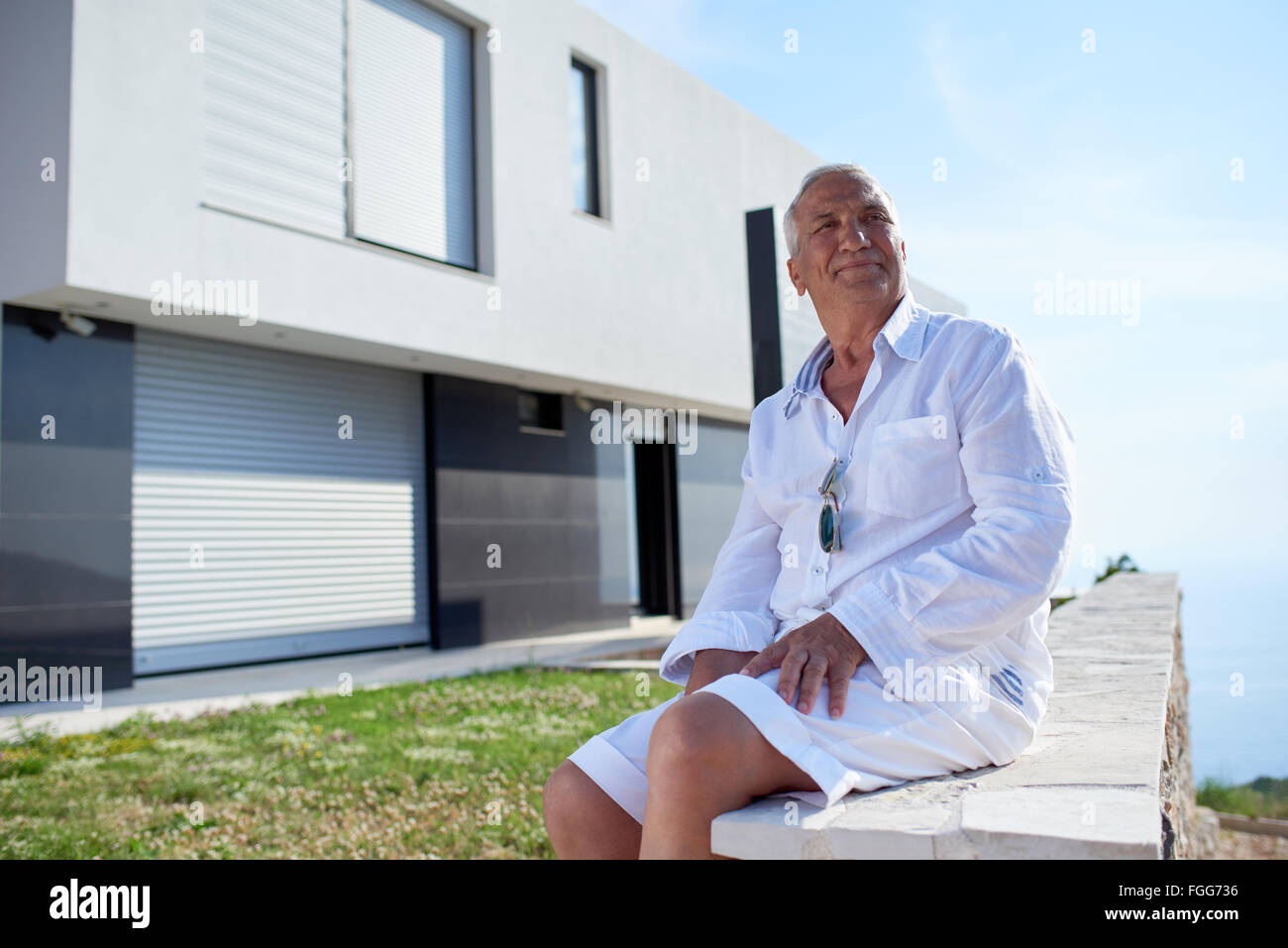 senior man in front of modern home Stock Photo - Alamy