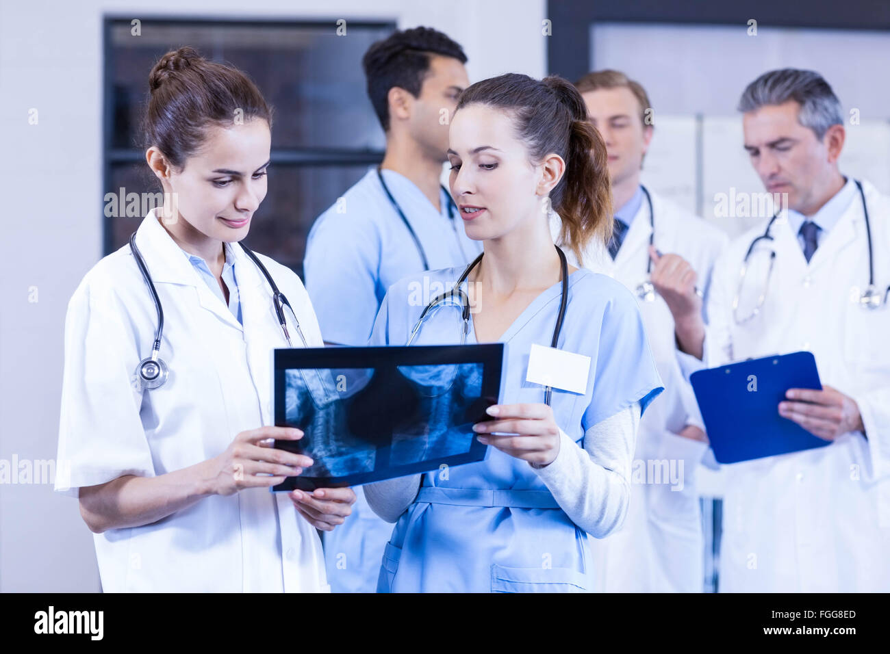 Female doctors checking x ray reports Stock Photo - Alamy