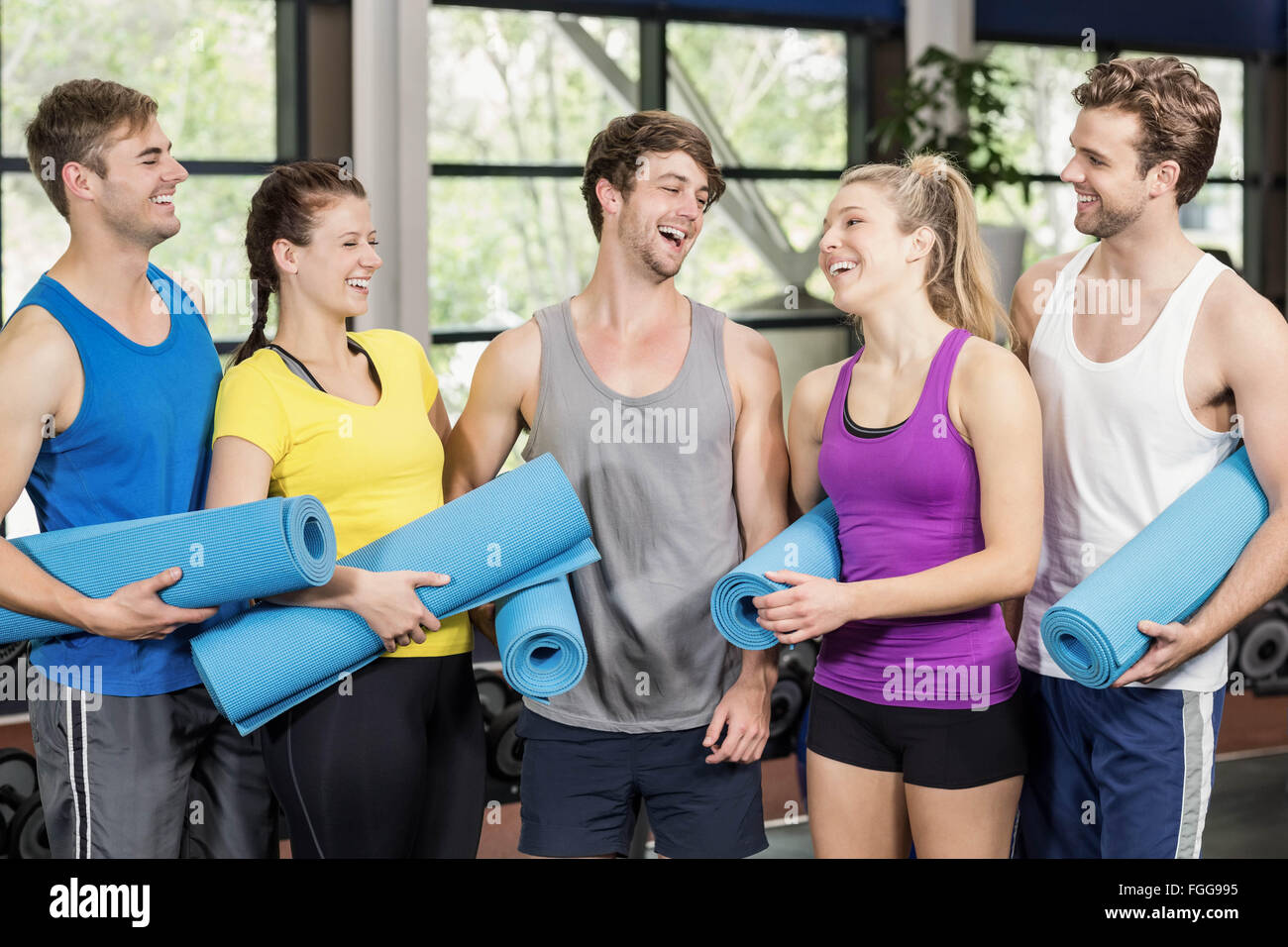 Group of people with fitness mat Stock Photo - Alamy