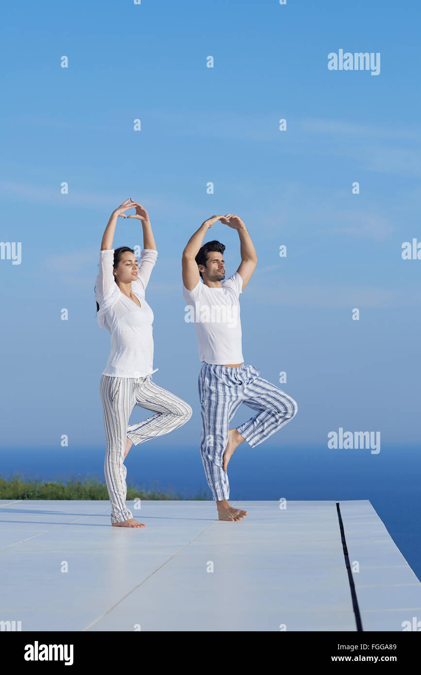 young couple practicing yoga Stock Photo - Alamy