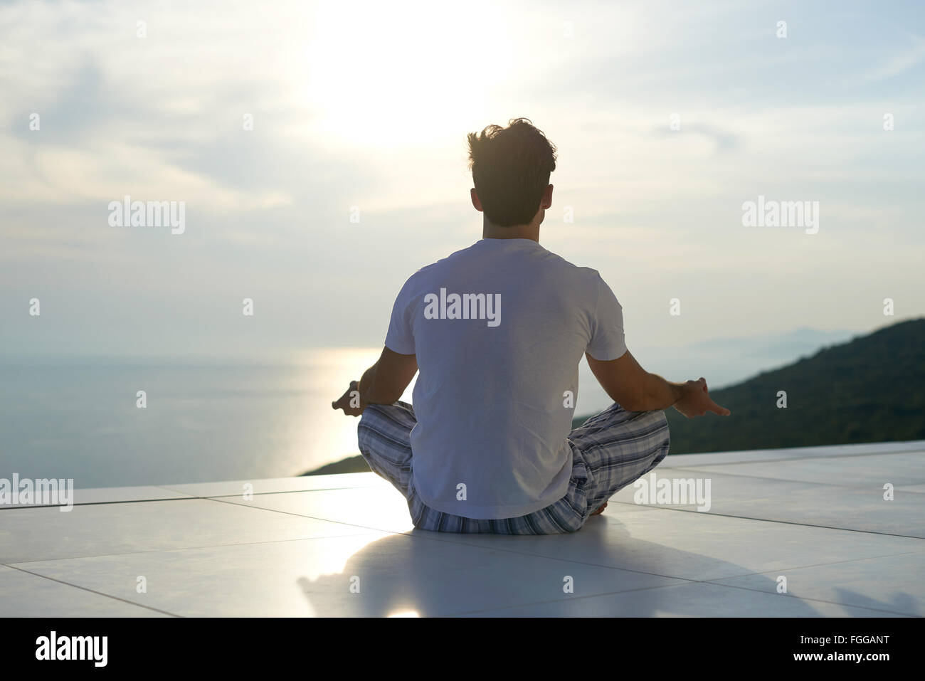 young man practicing yoga Stock Photo - Alamy