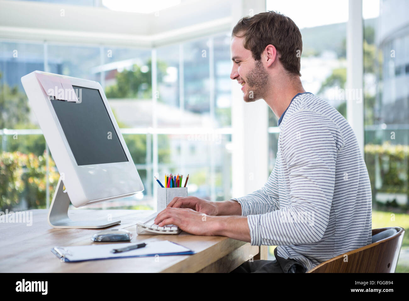 Handsome man working on computer Stock Photo - Alamy