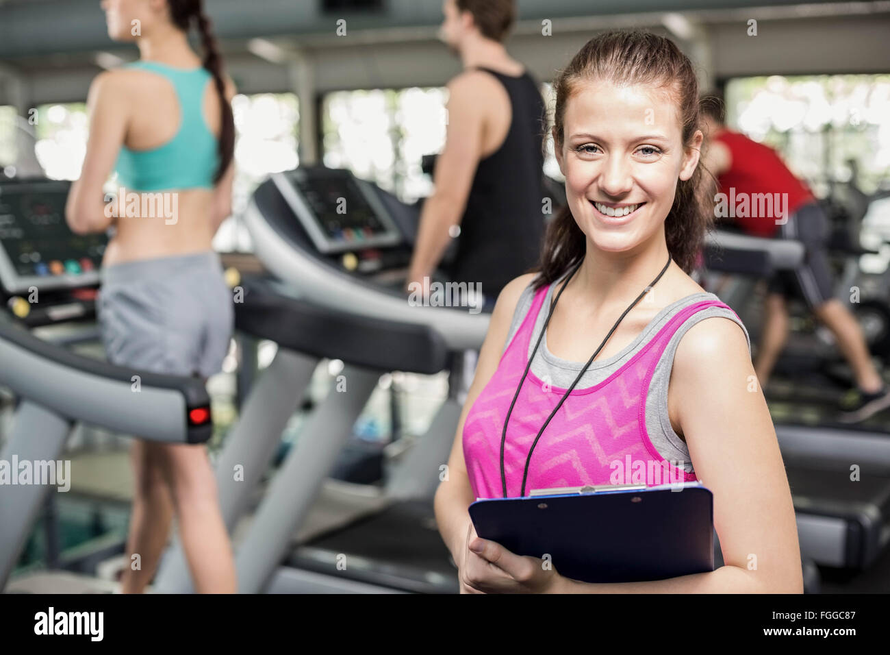 Female trainer smiling to camera Stock Photo - Alamy