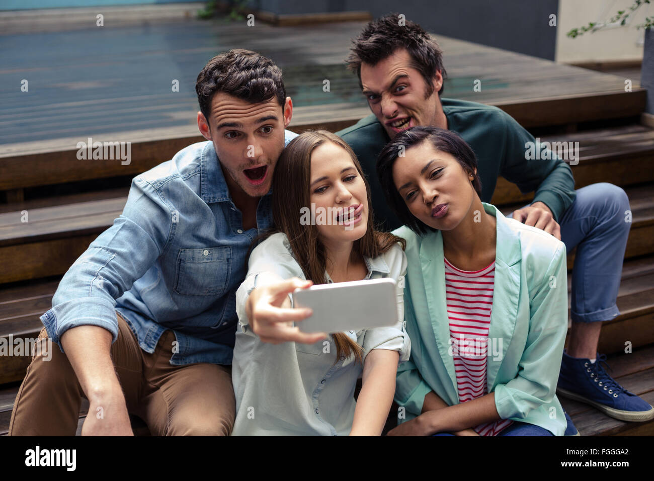 Happy friends taking selfie Stock Photo - Alamy