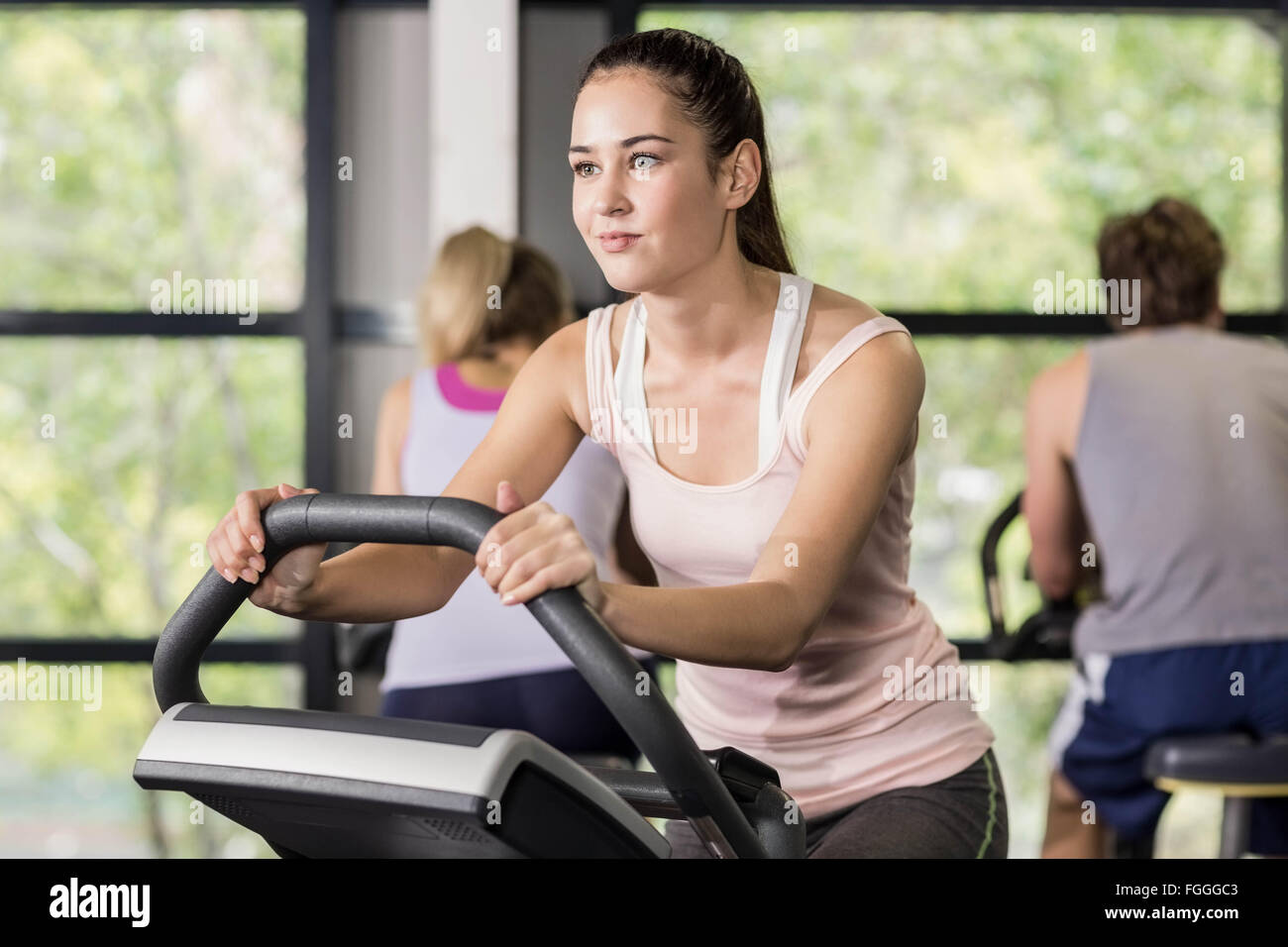 Fit woman doing exercise bike Stock Photo - Alamy
