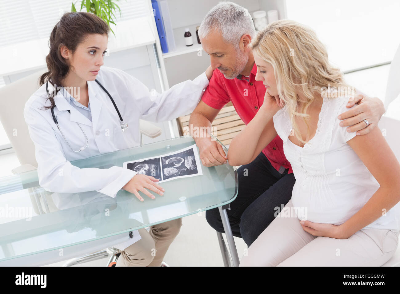 Doctor and nervous patient examining ultrasound Stock Photo - Alamy