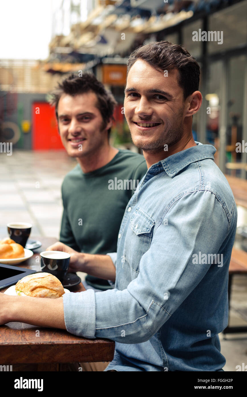 Happy friends having coffee together Stock Photo - Alamy