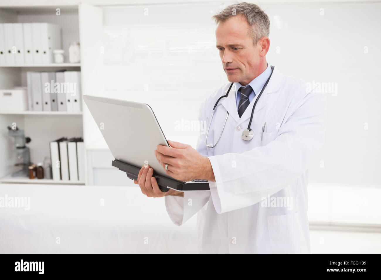 Doctor using his laptop Stock Photo - Alamy