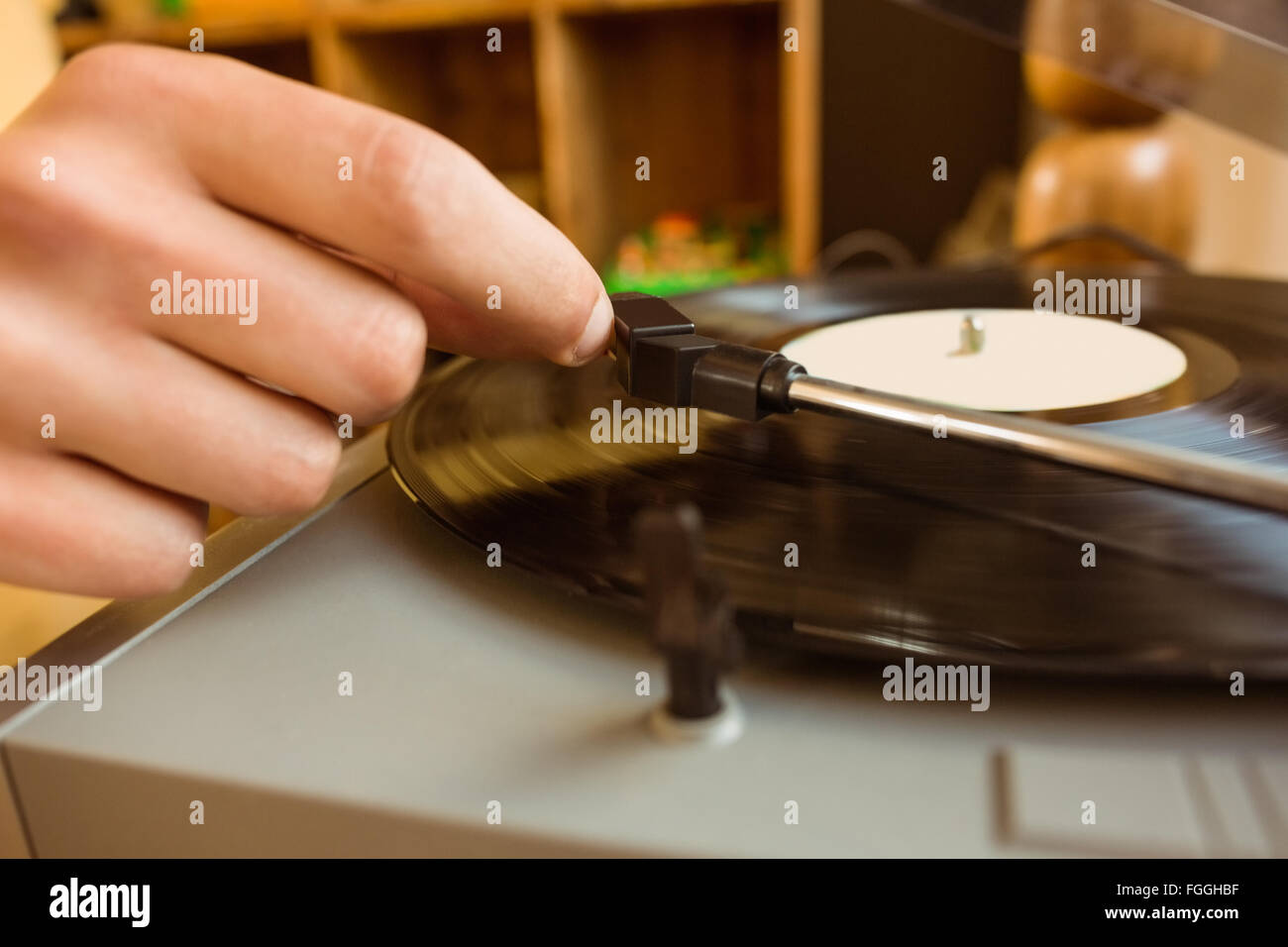 Young man putting on a vinyl Stock Photo - Alamy