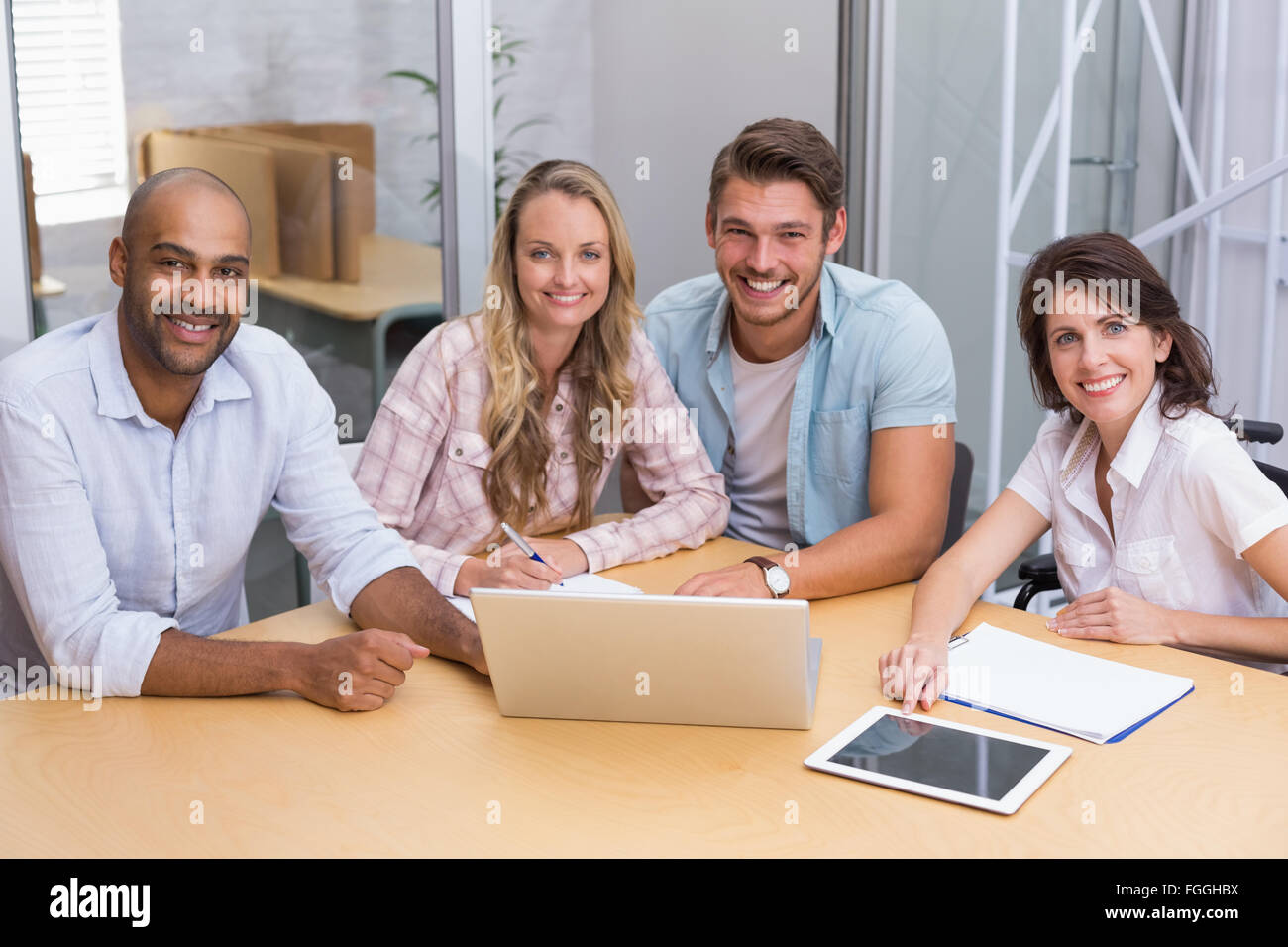 Smiling business people using tablet computer and laptop Stock Photo ...
