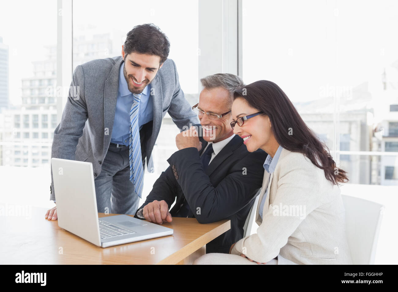 Smiling team enjoying a video Stock Photo - Alamy