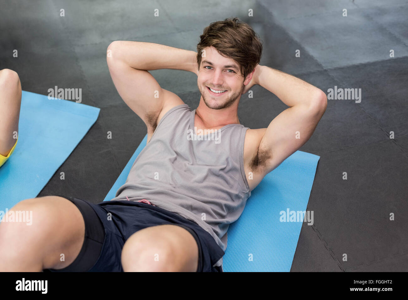 Handsome man working his abs Stock Photo - Alamy