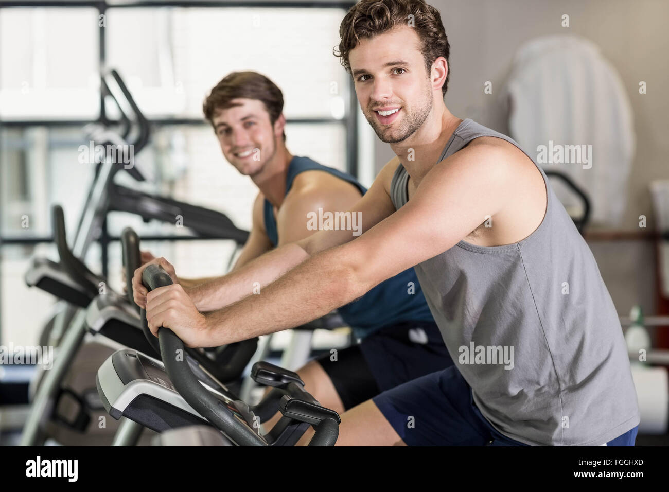 Fit people doing exercise bike Stock Photo - Alamy