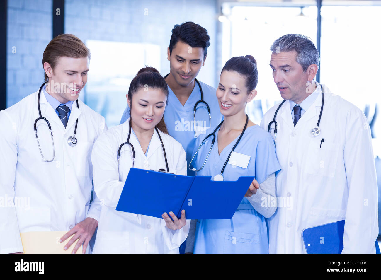 Doctors examining medical report Stock Photo - Alamy