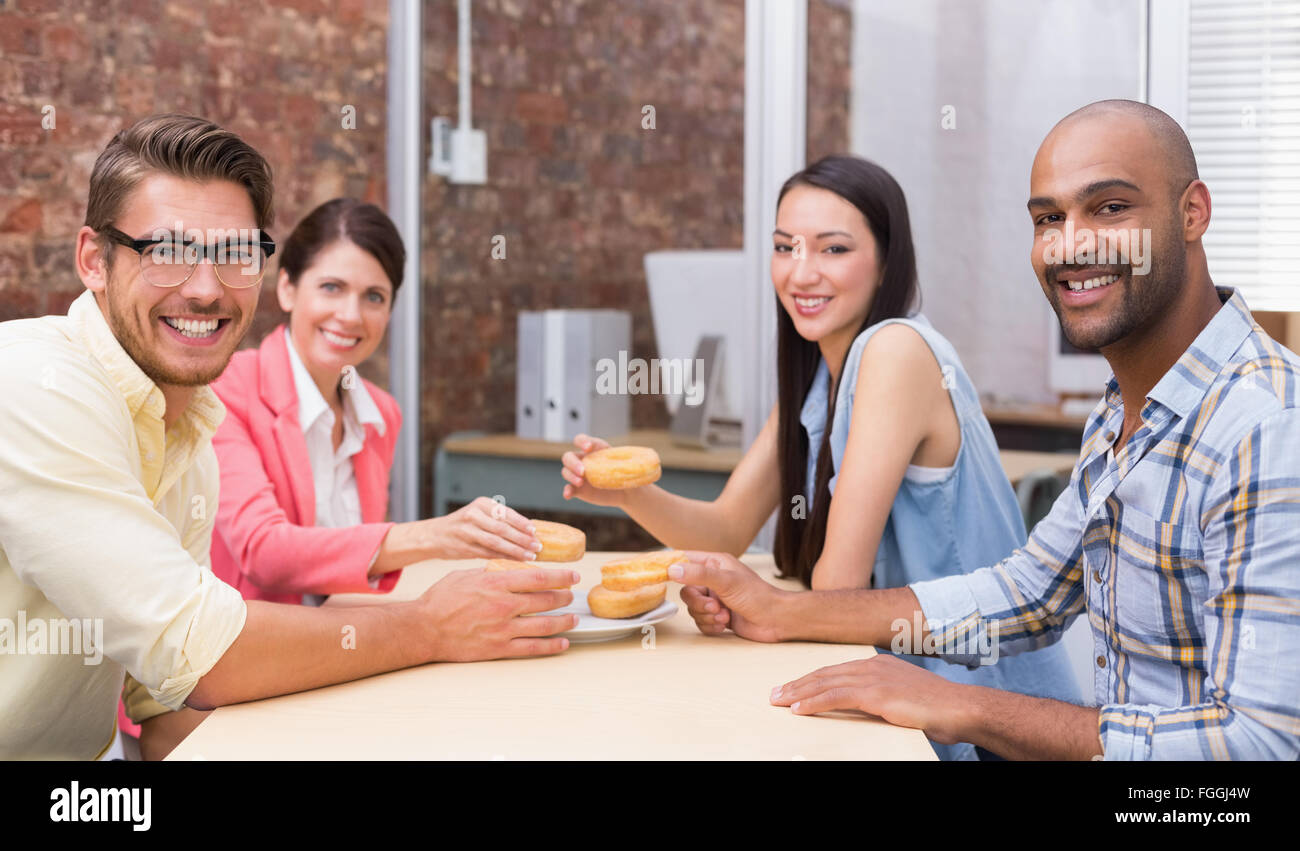 Business team taking doughnut during breaks Stock Photo - Alamy