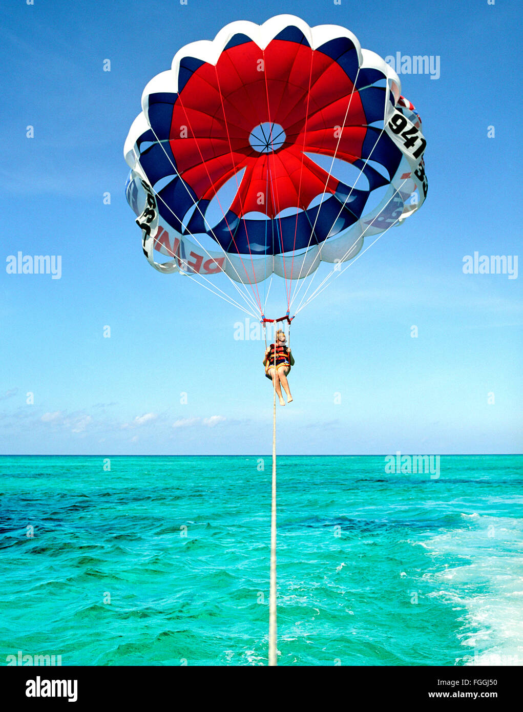 A foreign tourist parasails off of Grace Bay Beach, Providenciales ...