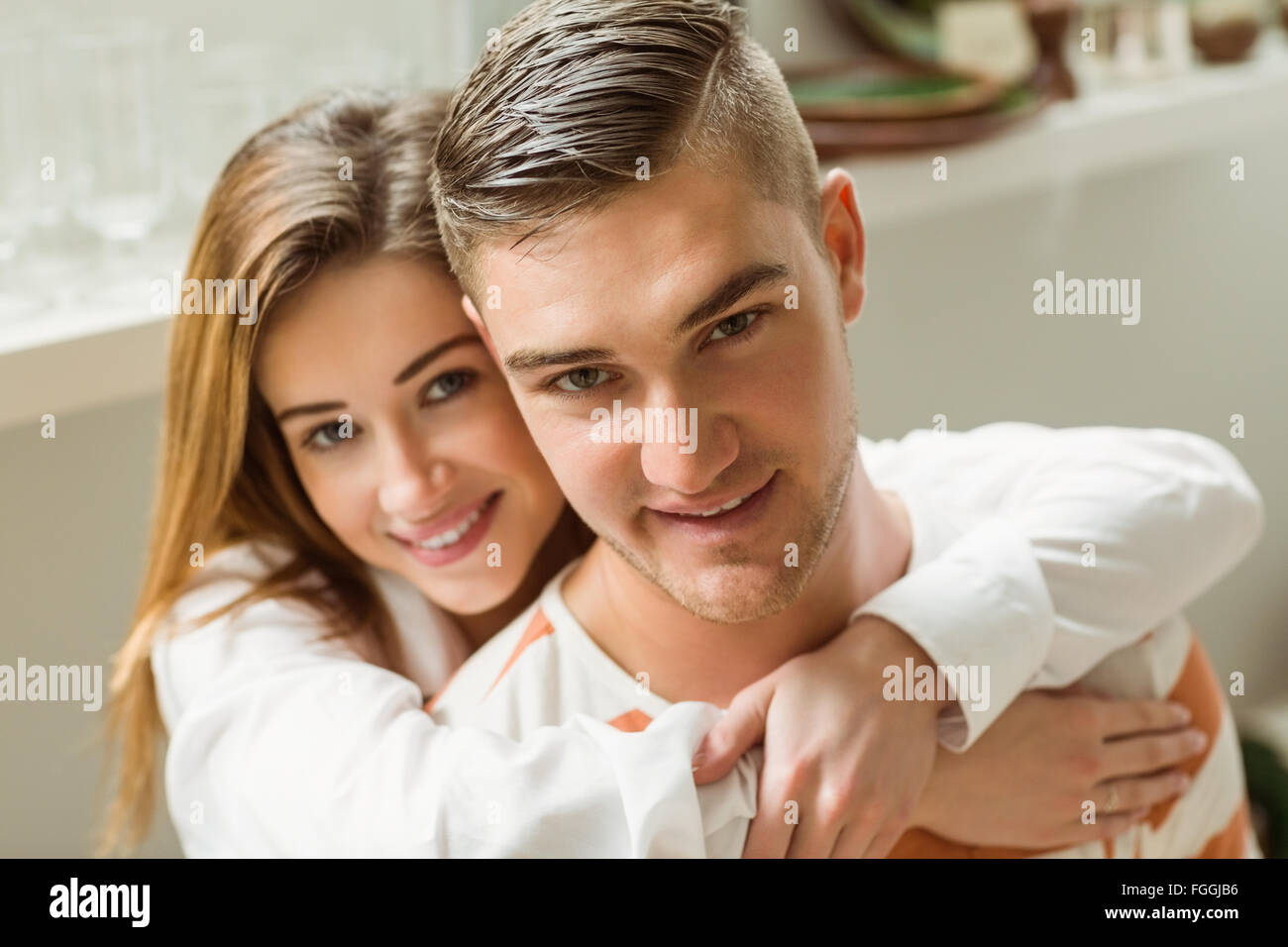 Cute couple smiling at camera Stock Photo - Alamy