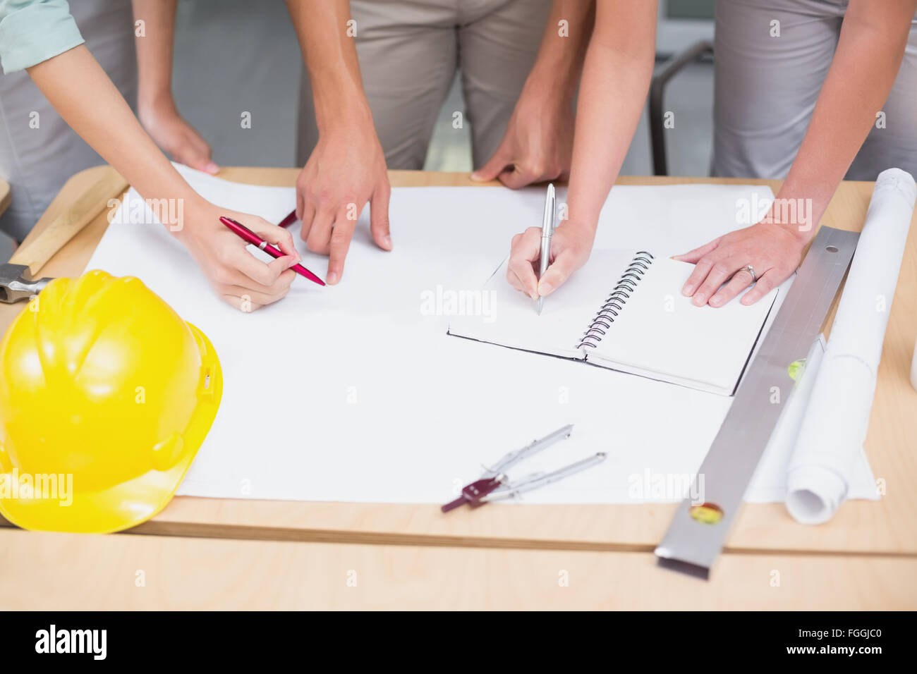 Architecture team working together at desk Stock Photo - Alamy